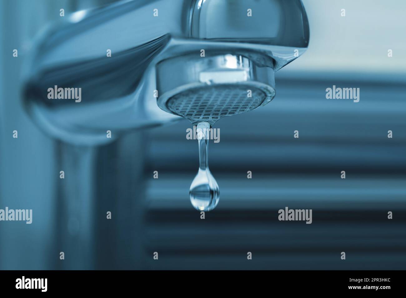 Water drop falling down from tap on blurred background, closeup Stock ...