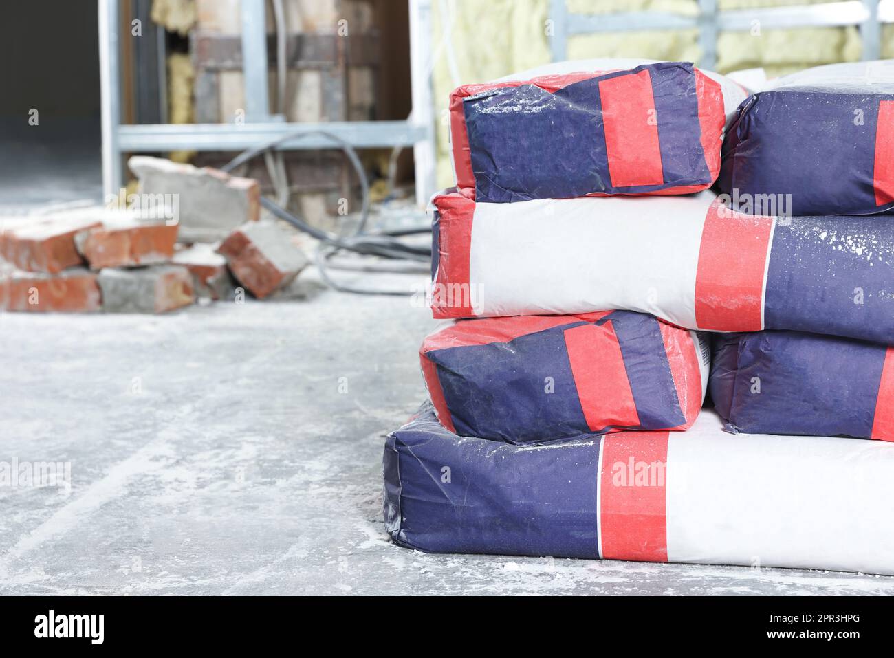 Cement powder in bags on stone floor indoors. Space for text Stock ...
