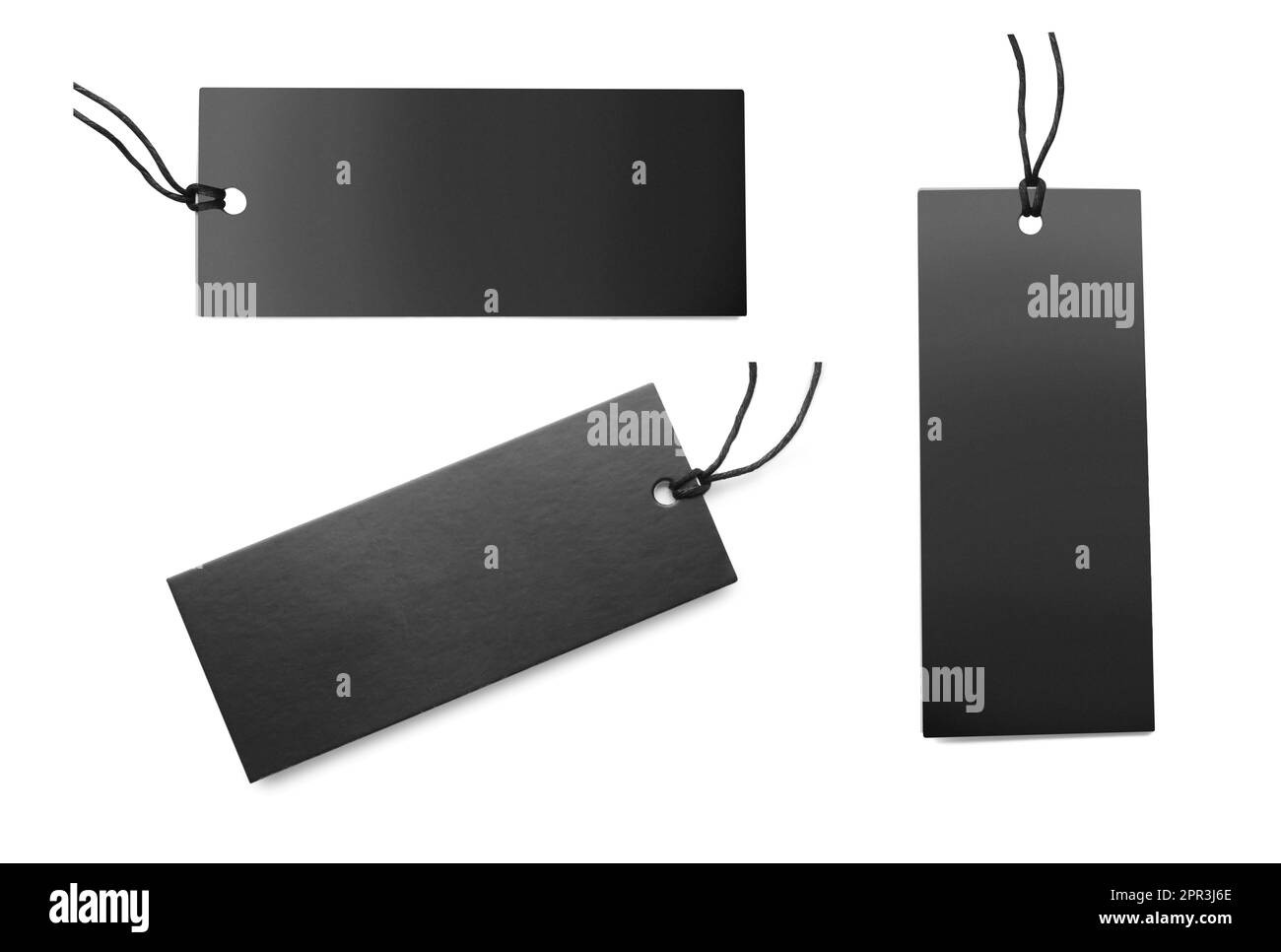 Set with black cardboard tags on white background, top view. Space for ...