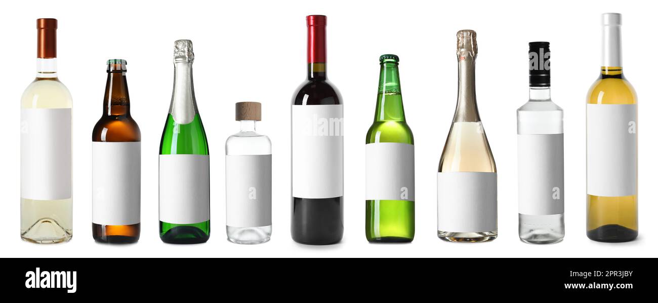 Set with bottles of different alcohol drinks on white background ...