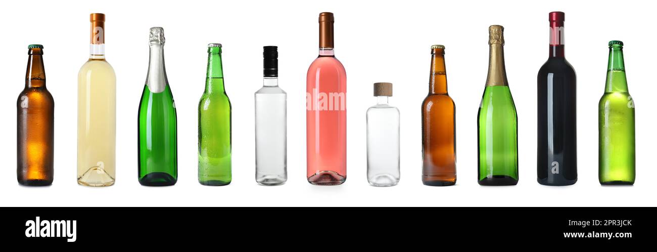 Set with bottles of different alcohol drinks on white background ...