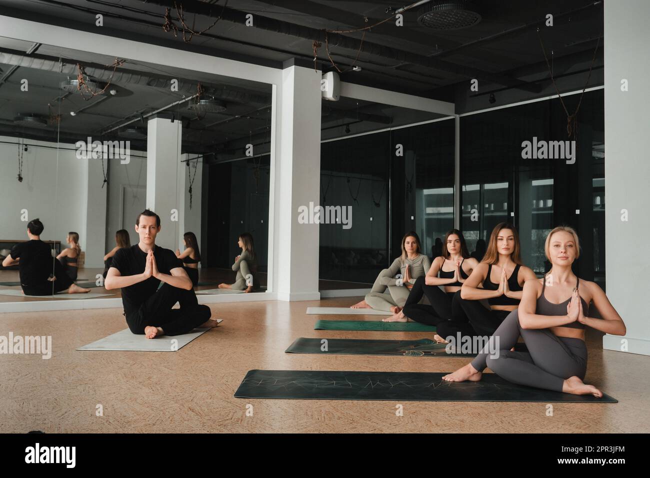 a group of girls do yoga in the gym under the guidance of a coach Stock ...