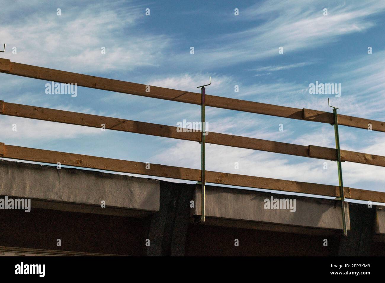fall arrest scaffolding on a construction site. roof with wooden ...