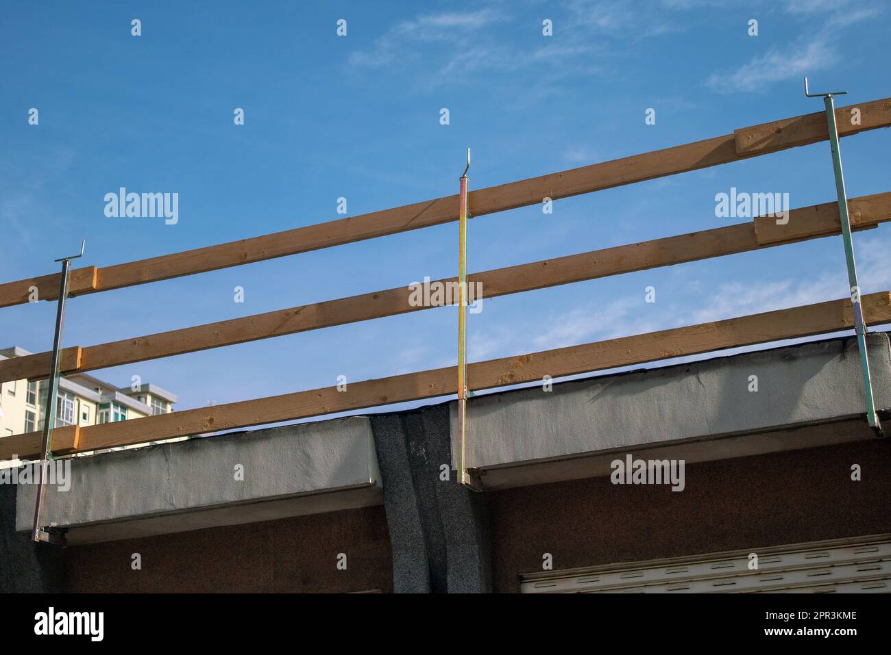 fall arrest scaffolding on a construction site. roof with wooden ...