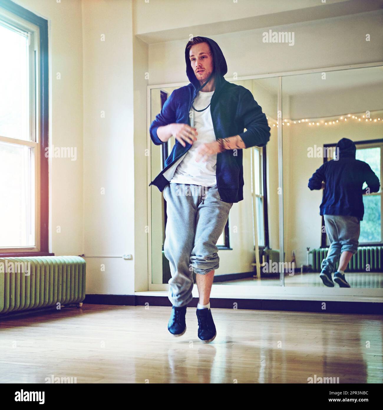 Making his mark through movement. a young man breakdancing in a studio ...