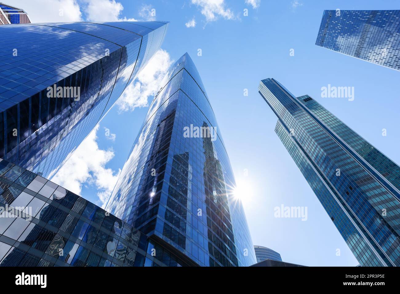 Modern glass silhouettes of skyscrapers in the city. Bottom view of ...