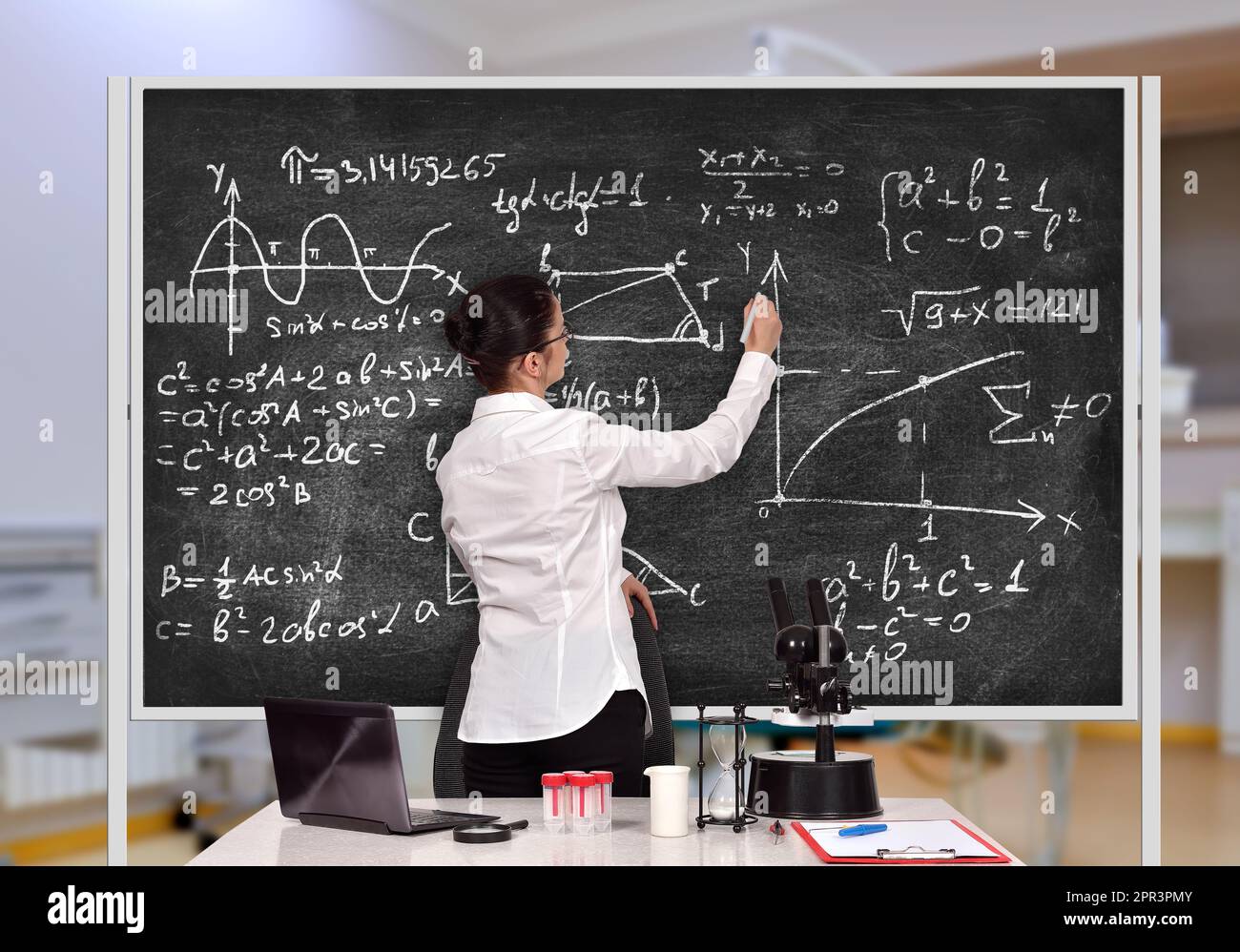 teacher in laboratory drawing formula on chalkboard Stock Photo - Alamy