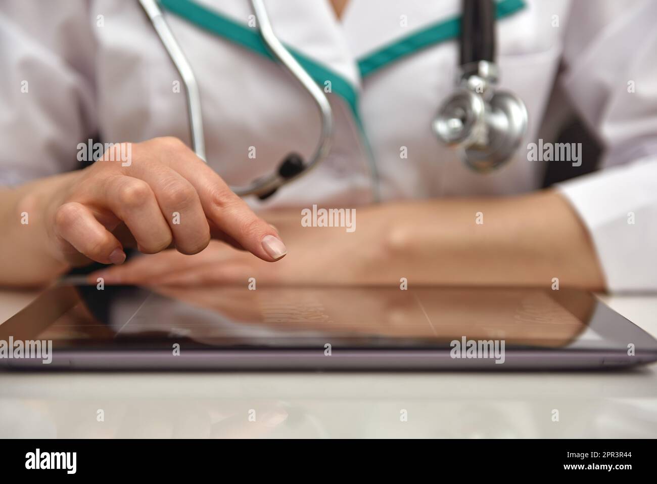 Female Doctor Examines X-ray Of Patient On Tablet. Close Up Stock Photo ...