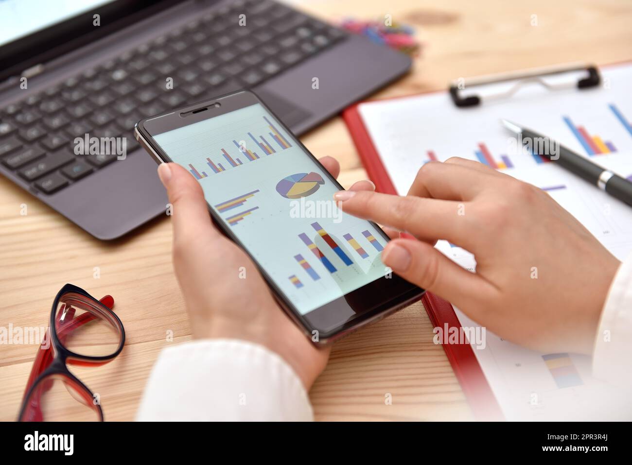Businesswoman Analyzing Chart On Cellphone Stock Photo - Alamy