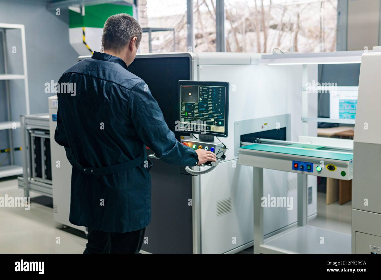 Perm, Russia - April 25, 2023: worker operates an automatic production ...
