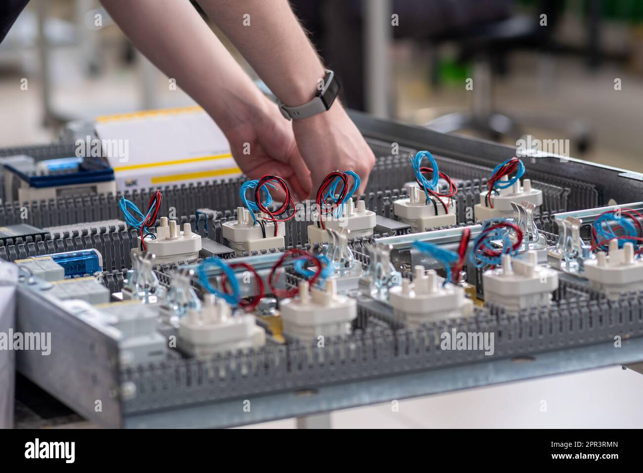 Perm, Russia - April 25, 2023: worker`s hands assembling charging ...