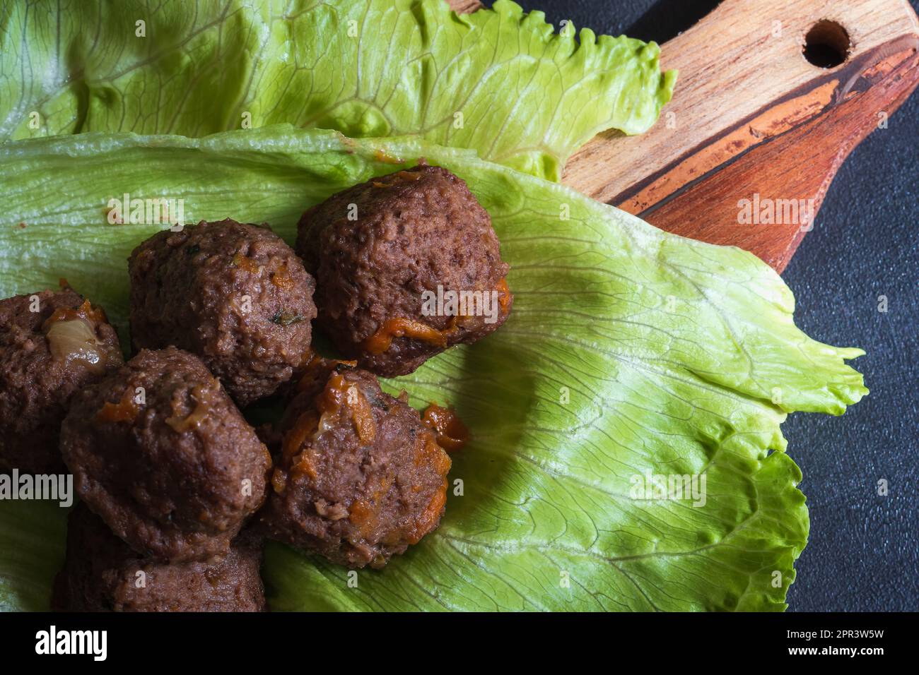 Fried cooked beef and pork meat balls on lettuce leafs closeup Stock ...