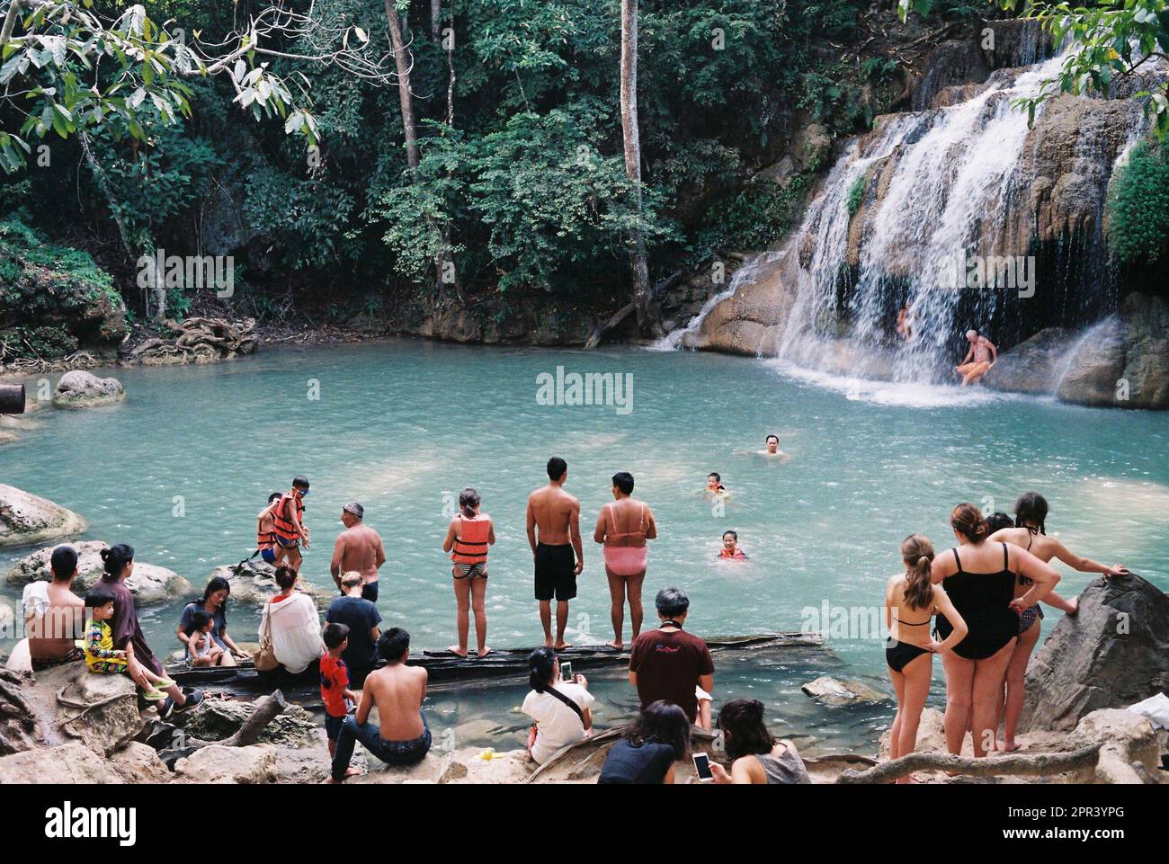 Clear waterfall full of fish and tourists Stock Photo - Alamy