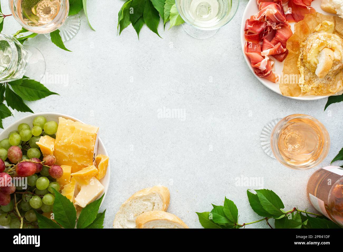 Top view of table with rose and white wine in glasses, plates with ...