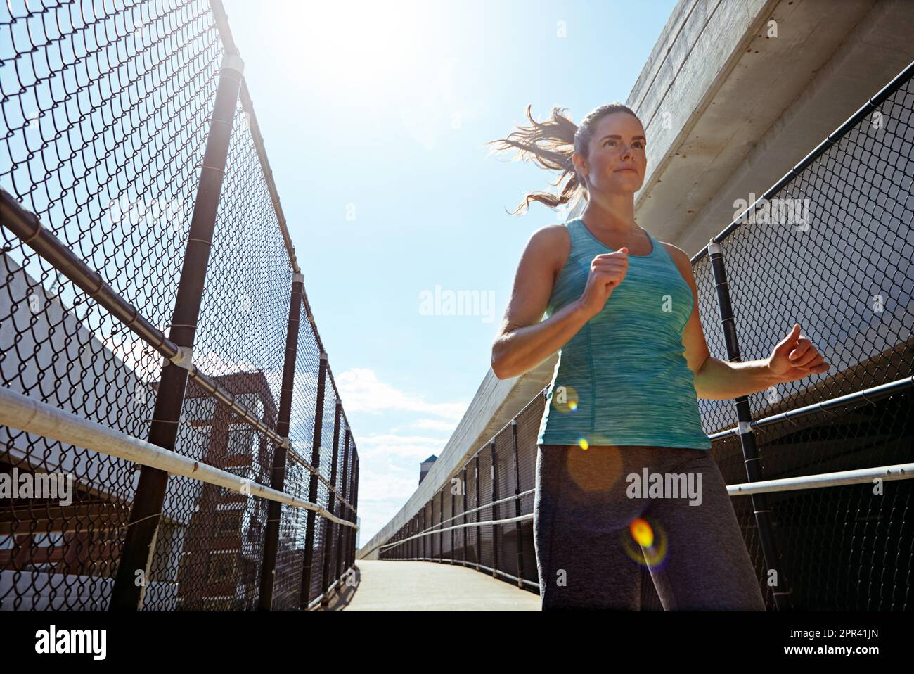 Im strict with my exercise routine. a sporty young woman running on a ...