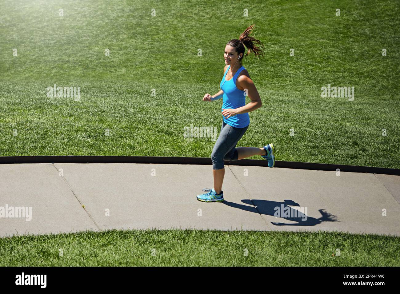 Running without a single care in the world. a young woman listening to ...