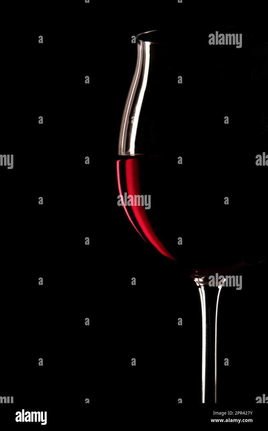 red wine glass in front of black background Stock Photo - Alamy