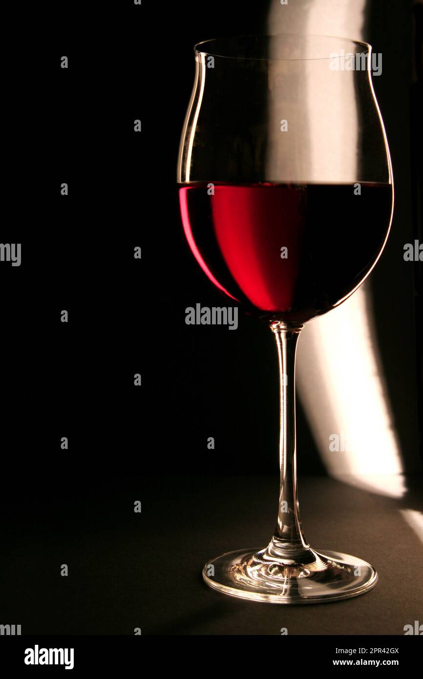 red wine glass in front of black background Stock Photo - Alamy