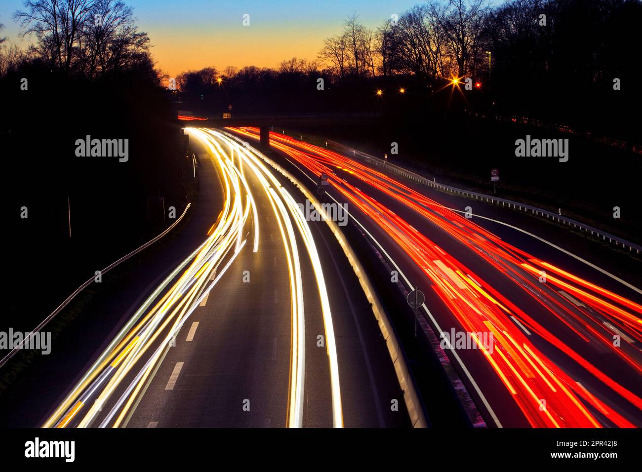 light streaks of driving cars on motorway A52 in the night, Germany ...