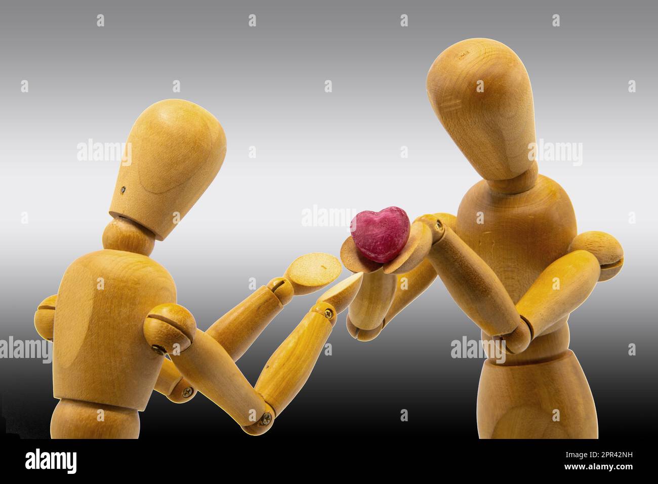wooden mannequin offering a heart, I give you my heart Stock Photo - Alamy