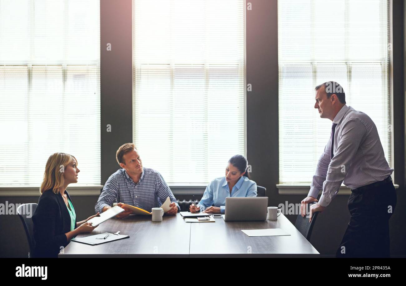 Making the most of their meeting with excellent teamwork. a group of colleagues having a meeting ...