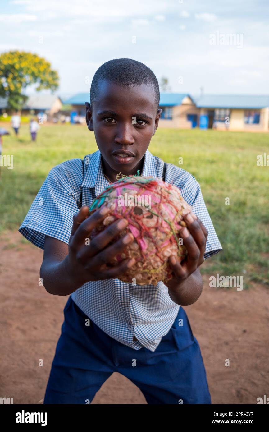 Boy with homemade football made with scrap rubber and elastic, Rwanda ...