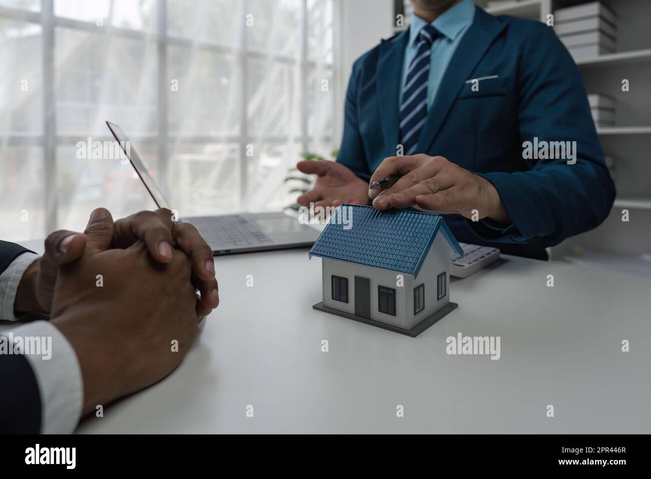 real estate agent holding house to his client after signing contract ...
