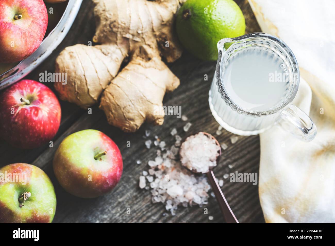 Bottle of apple cider vinegar on rustic background with organic apples ...