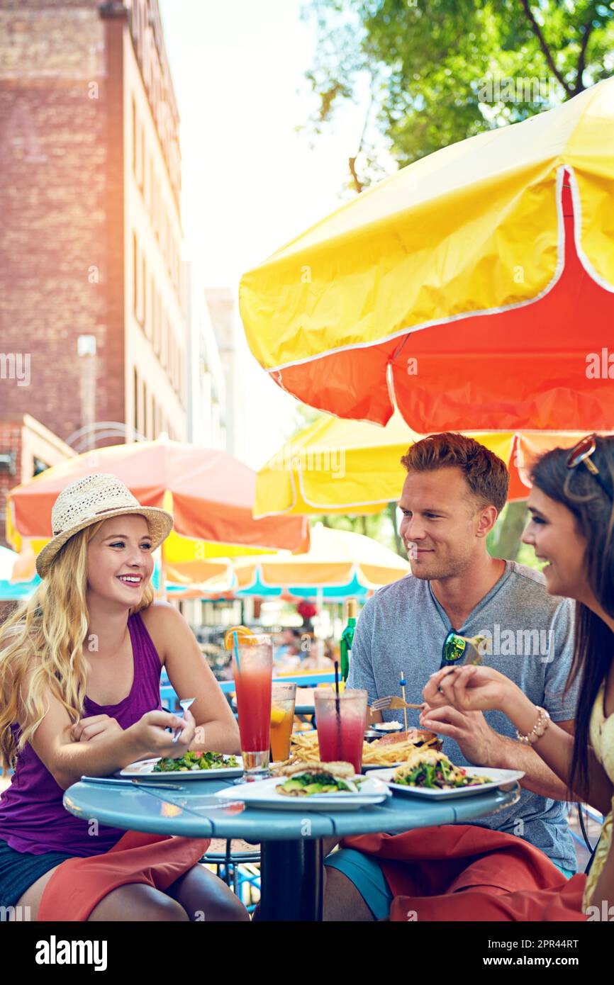 The perfect way to kickstart summer. three young friends sitting at an ...