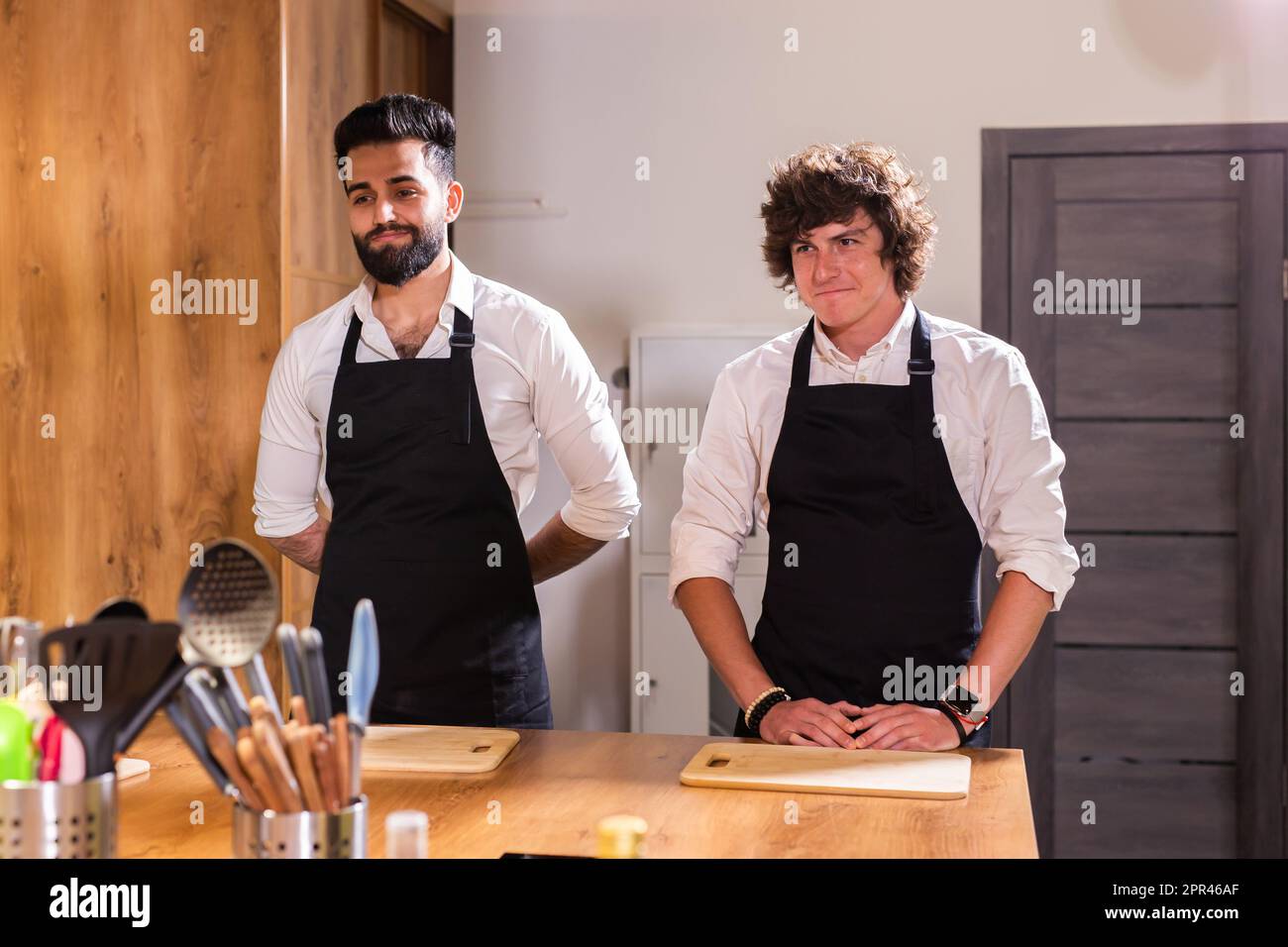 Cooking course - senior male chef in cook uniform teaches young people ...