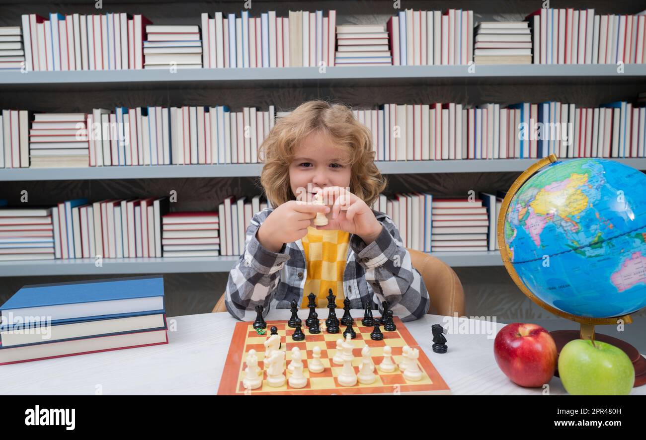 Little chess player. Kid playing chess. Clever child thinking about ...