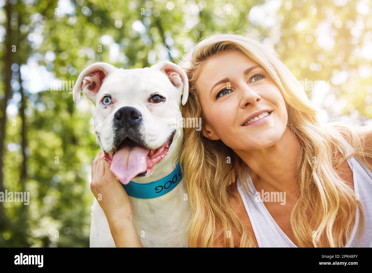 Nothing is better than being loved by a dog. a young woman spending ...