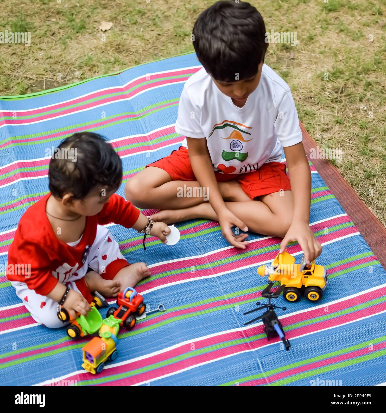Two happy boys in society park, happy Asian brothers who are smiling ...