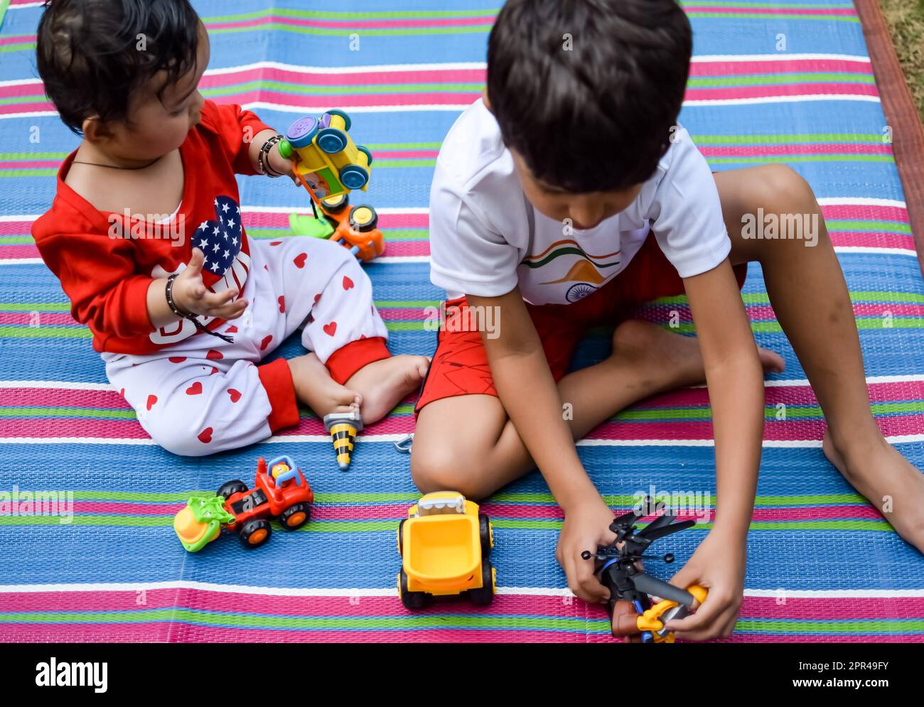 Two happy boys in society park, happy Asian brothers who are smiling ...