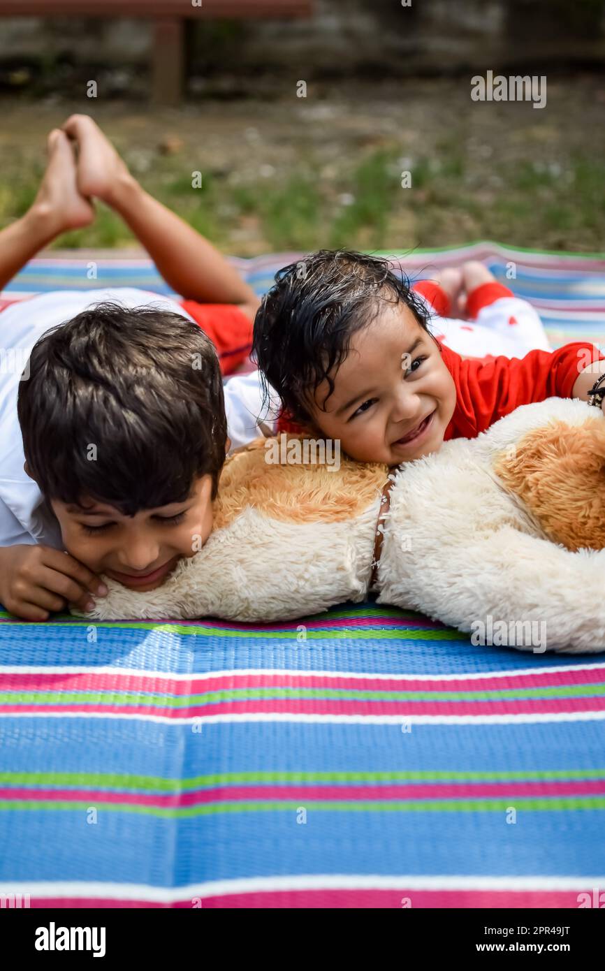 Two happy boys in society park, happy Asian brothers who are smiling ...