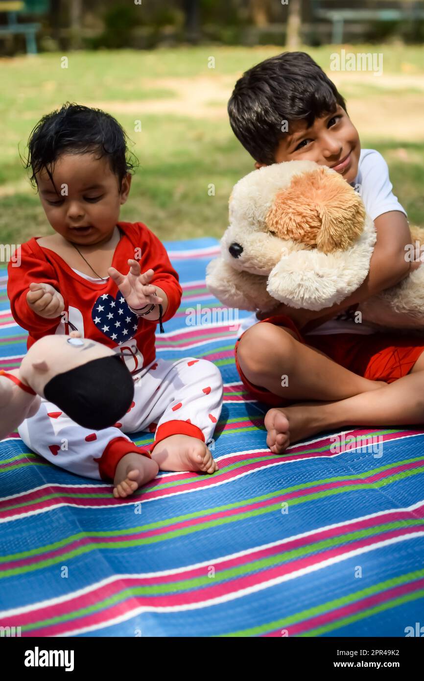 Two happy boys in society park, happy Asian brothers who are smiling ...