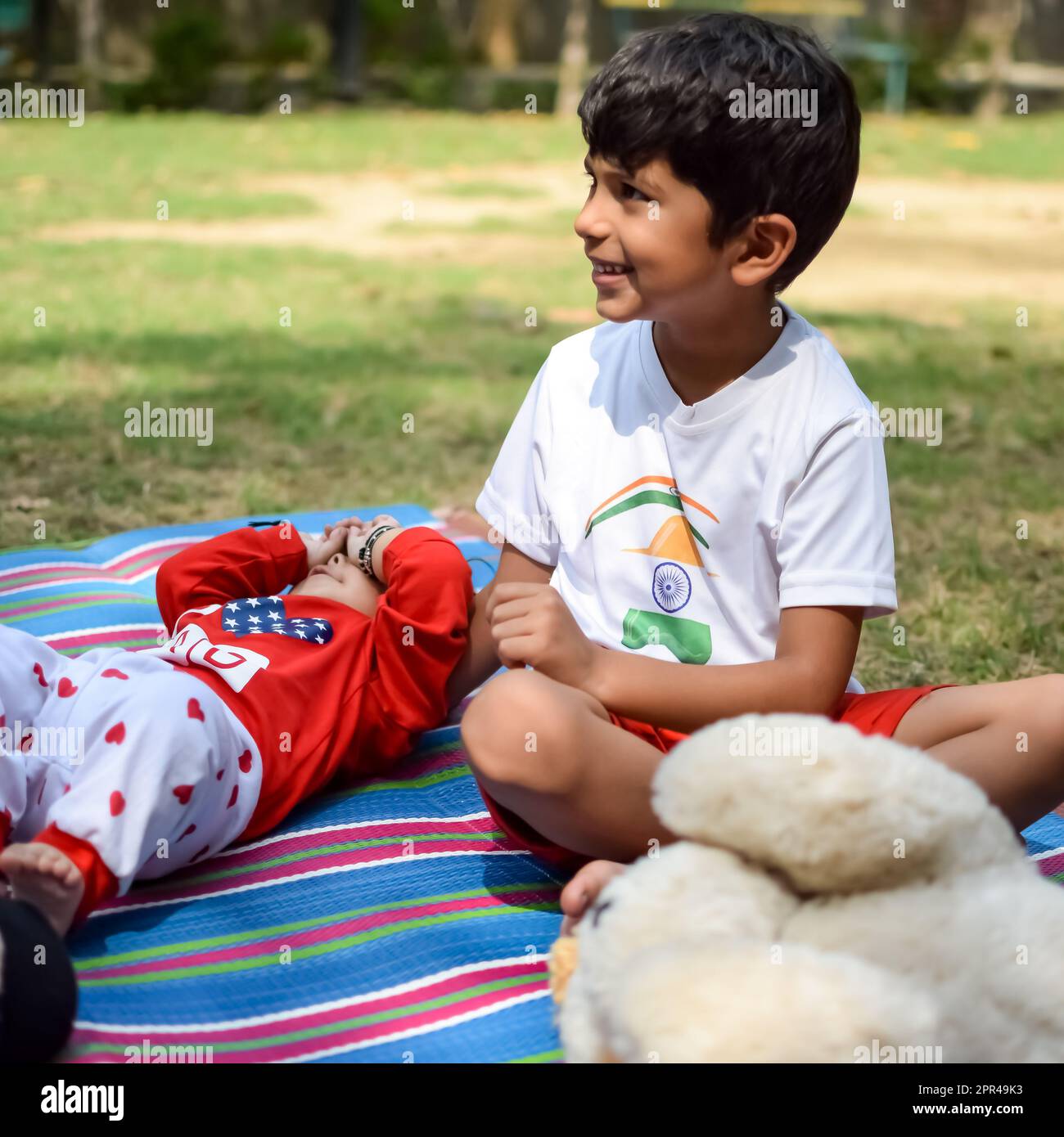 Two happy boys in society park, happy Asian brothers who are smiling ...