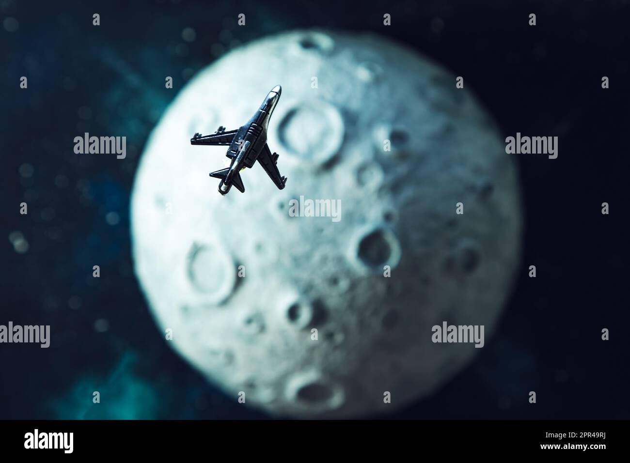 Toy plane flies near the moon, starry background. The concept of space ...