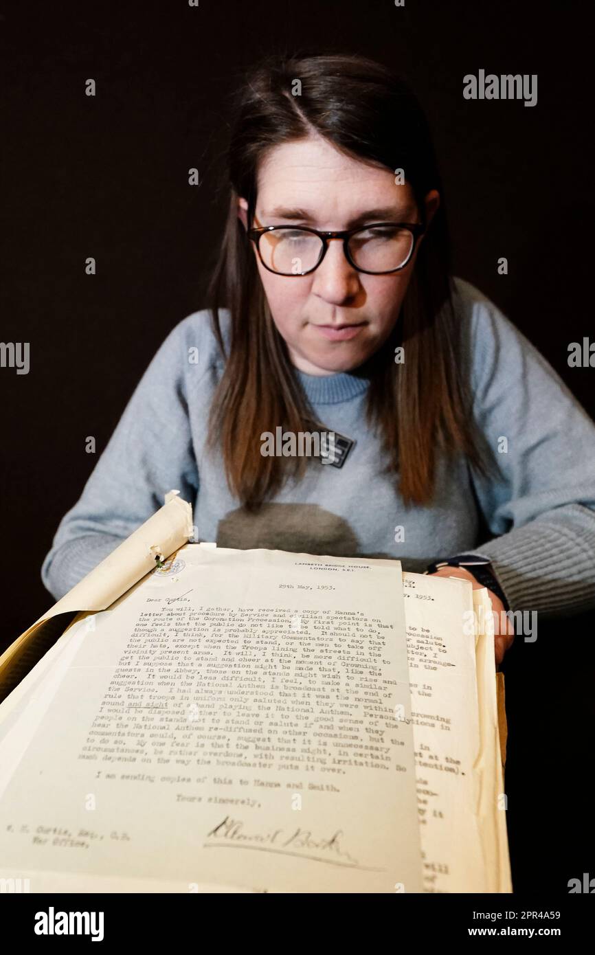 Jessamy Carlson, Record Specialist at The National Archive looks at a ...