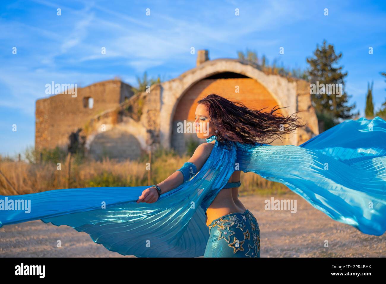 Oriental dancer dressed in blue with Isis Wings of the same color ...