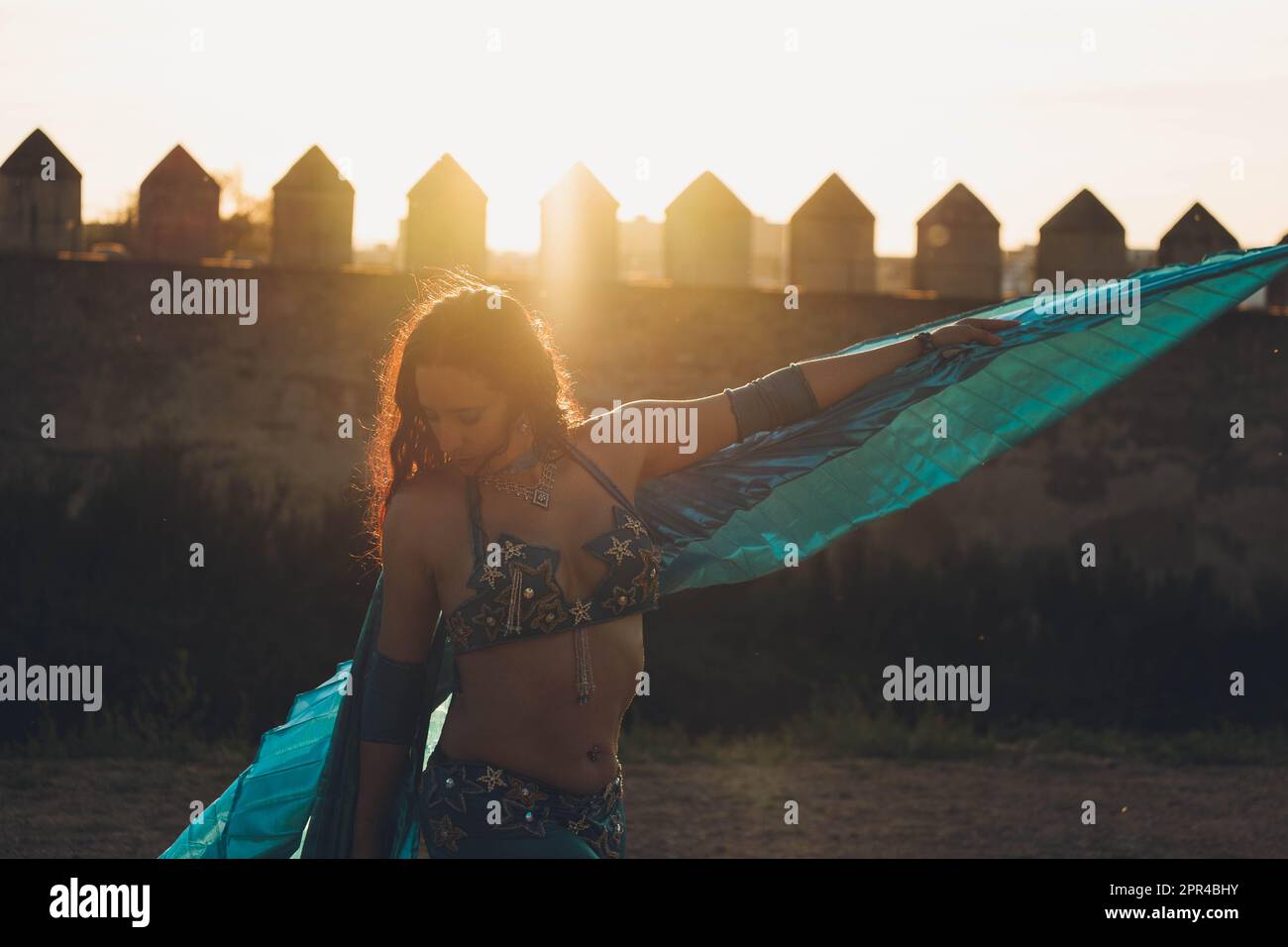 Oriental dancer dressed in blue with Isis Wings of the same color ...