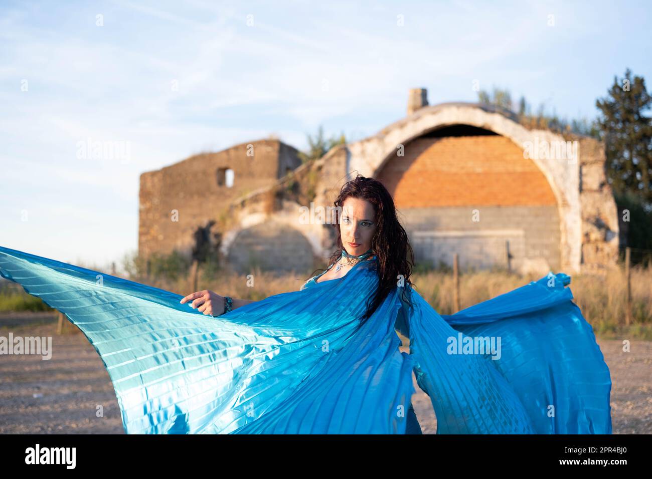 Oriental dancer dressed in blue with Isis Wings of the same color ...