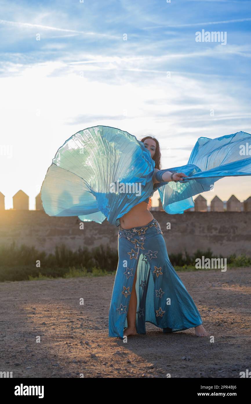 Oriental dancer dressed in blue with Isis Wings of the same color ...