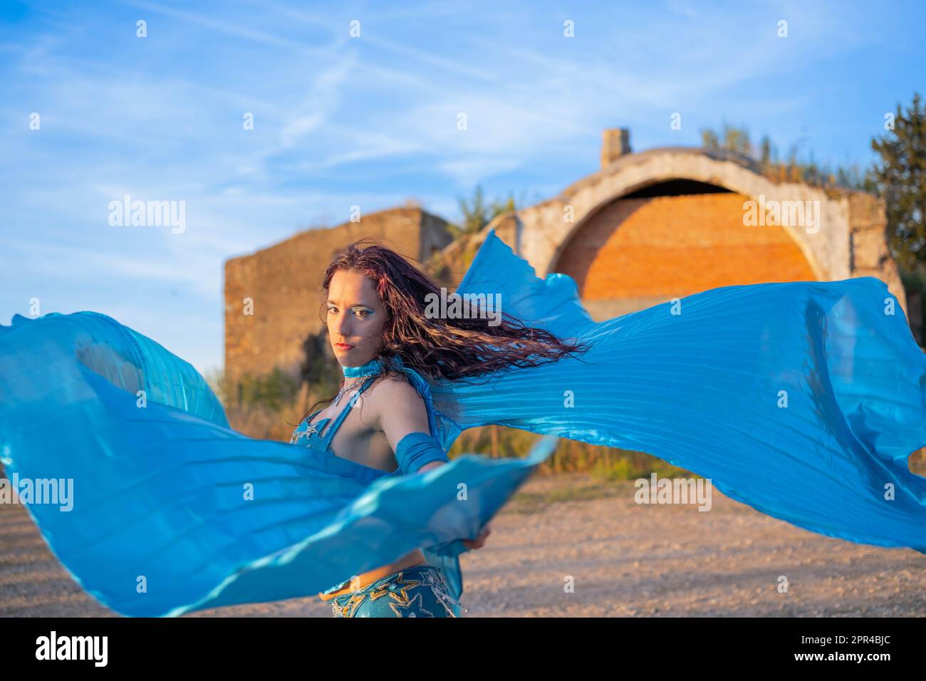 Oriental dancer dressed in blue with Isis Wings of the same color ...