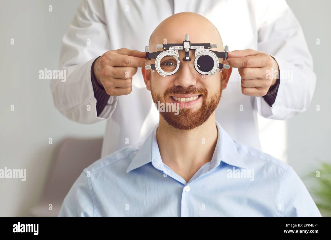 Optometrist uses ophthalmic equipment to see how many diopters his ...
