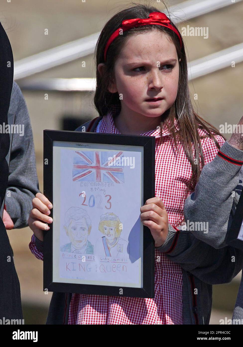 Schoolchildren hold up drawing as the wait outside Liverpool Central ...