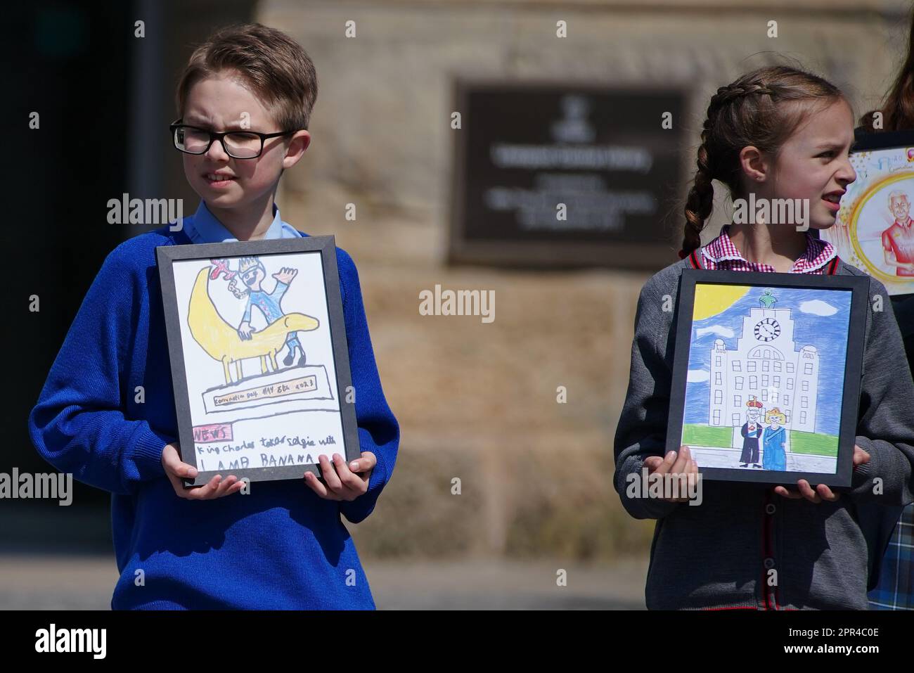 Schoolchildren hold up drawing as the wait outside Liverpool Central ...