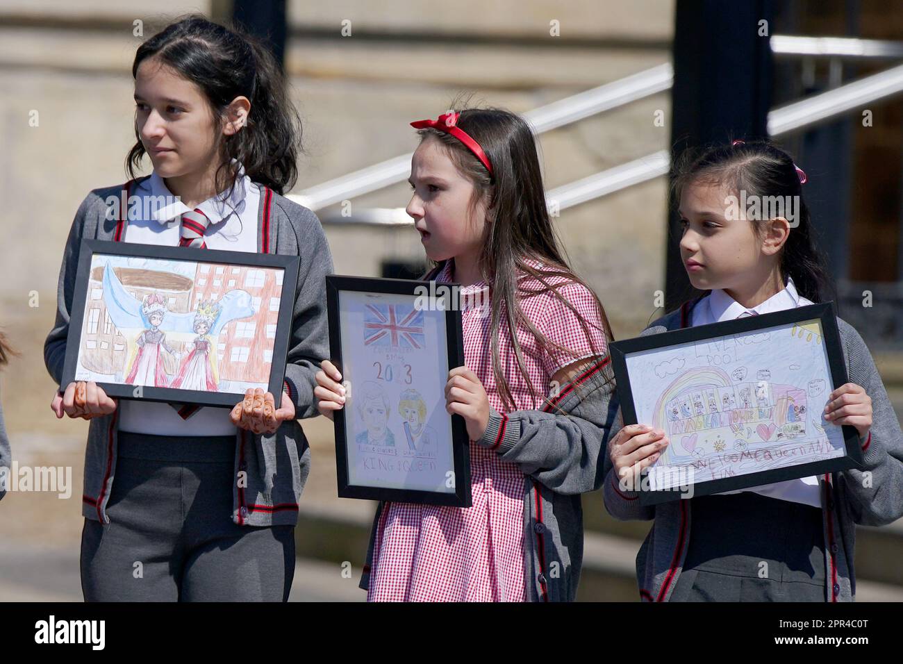 Schoolchildren hold up drawing as the wait outside Liverpool Central ...