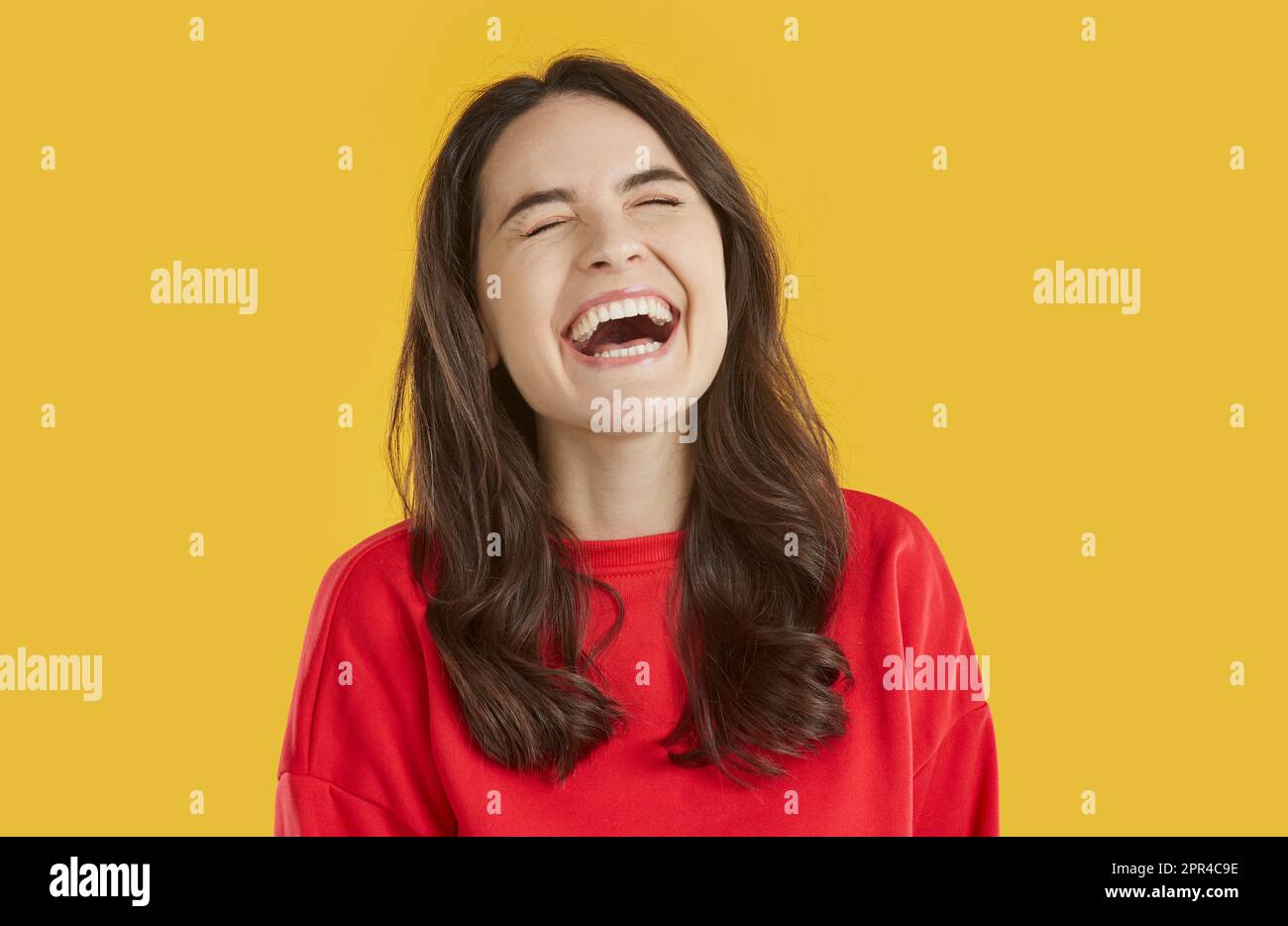 Happy young woman laughing happily at very funny joke isolated on ...