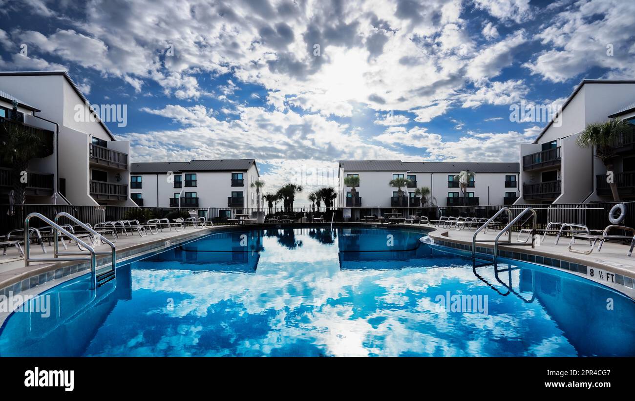 A picture of a sparkling blue pool in a luxurious resort setting Stock ...